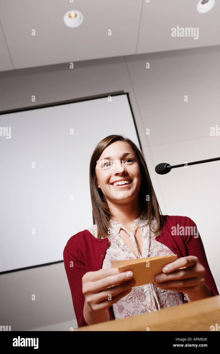 Student with paper notes giving presentation Stock Photo - Alamy