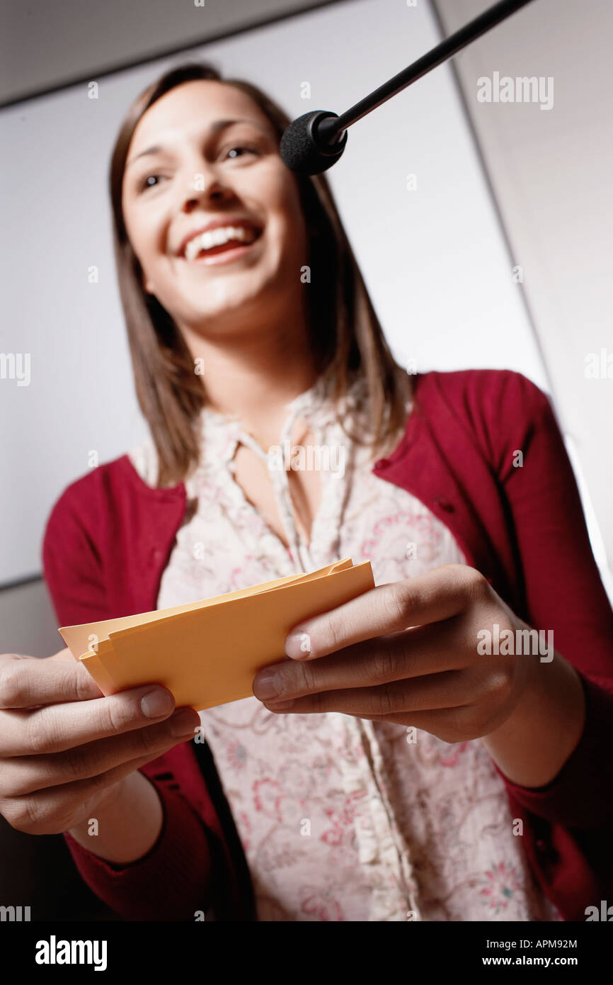 Student with paper notes giving presentation Stock Photo - Alamy