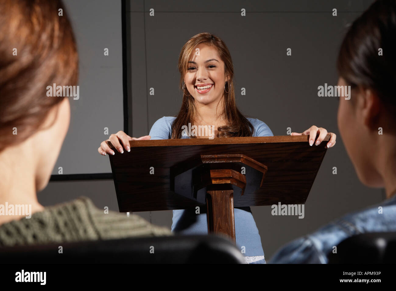 Woman giving a presentation to two students Stock Photo - Alamy