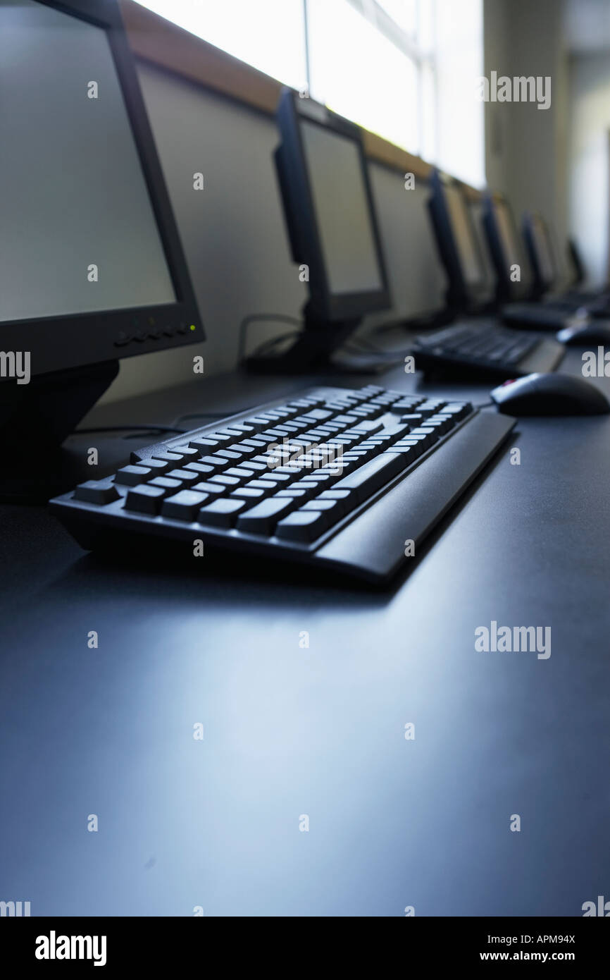 Row of computers on table Stock Photo - Alamy