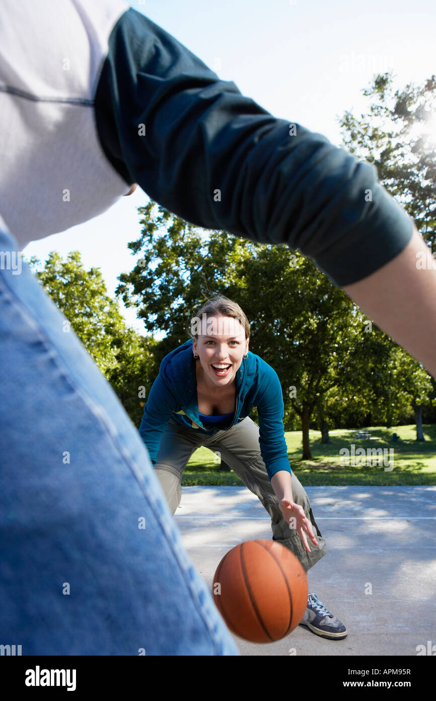 Young couple playing basketball Stock Photo - Alamy
