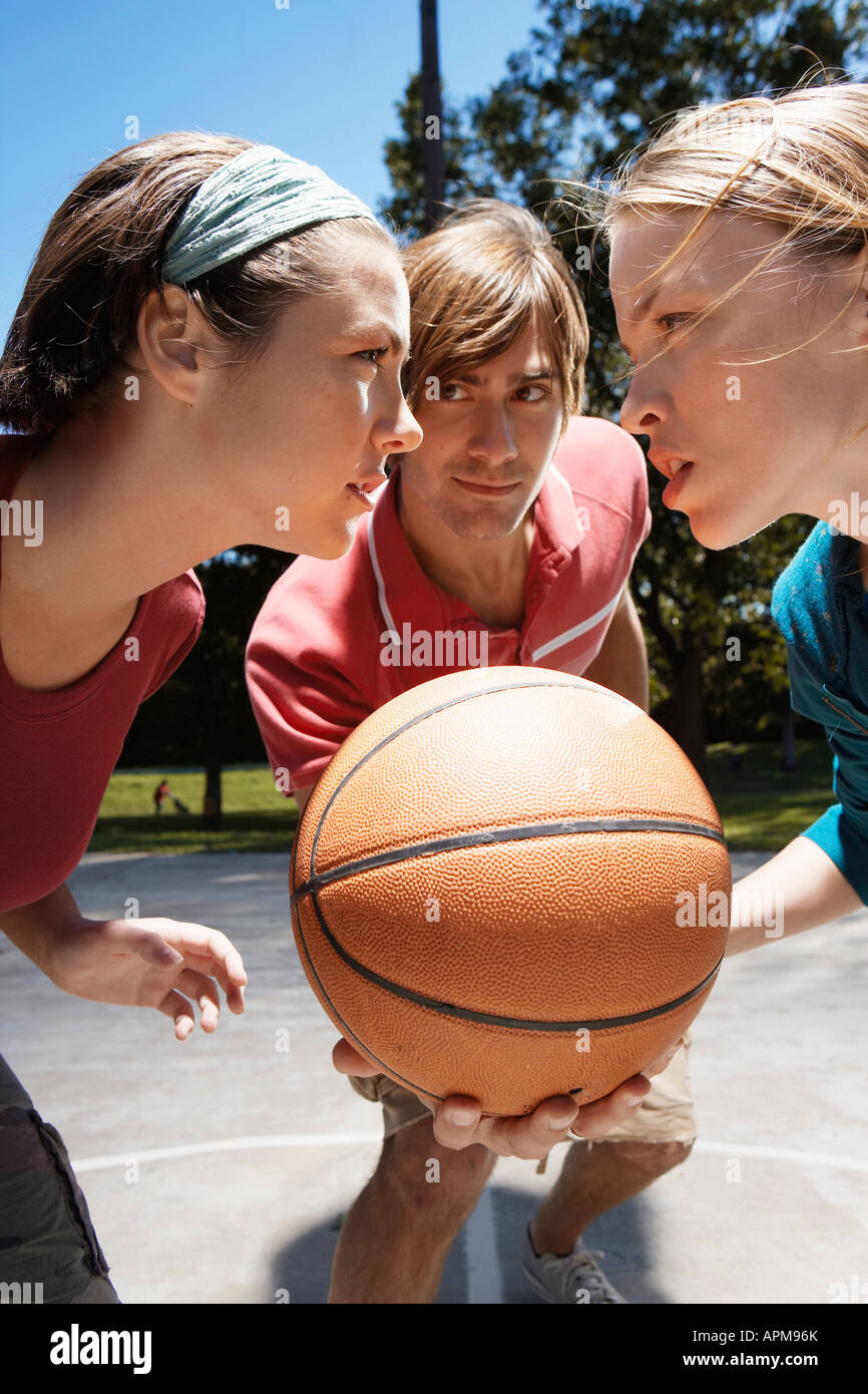 Three people playing basketball Stock Photo - Alamy