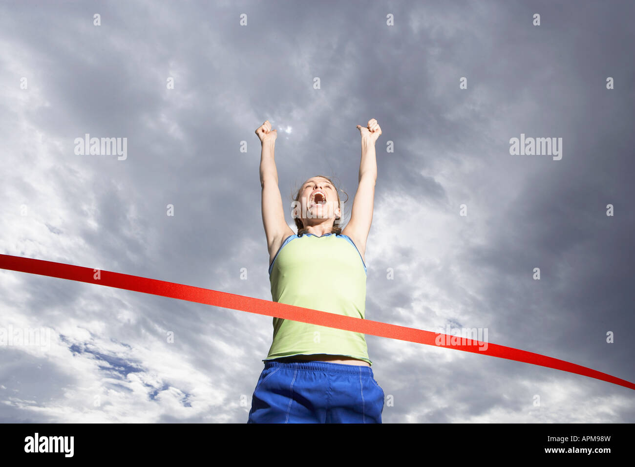 Female runner crossing finishing line (low angle view Stock Photo - Alamy