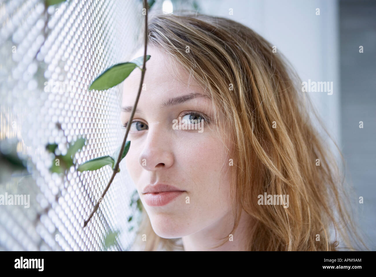 Young woman by window (portrait Stock Photo - Alamy
