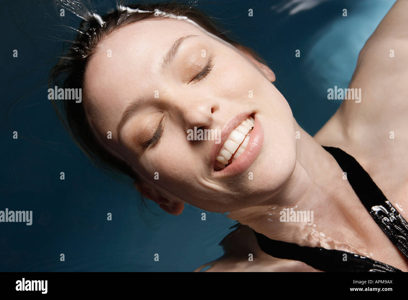 Young woman floating on water (directly above Stock Photo - Alamy