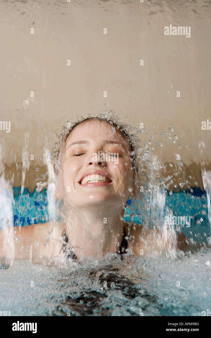 Young woman under waterfall in spa Stock Photo - Alamy
