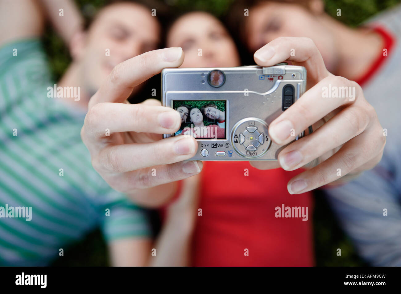 Three friends photographing themselves (directly above Stock Photo - Alamy