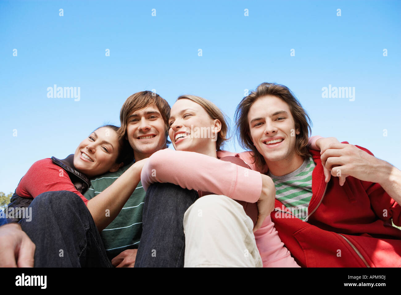Four friends under clear sky (portrait, low angle view Stock Photo - Alamy