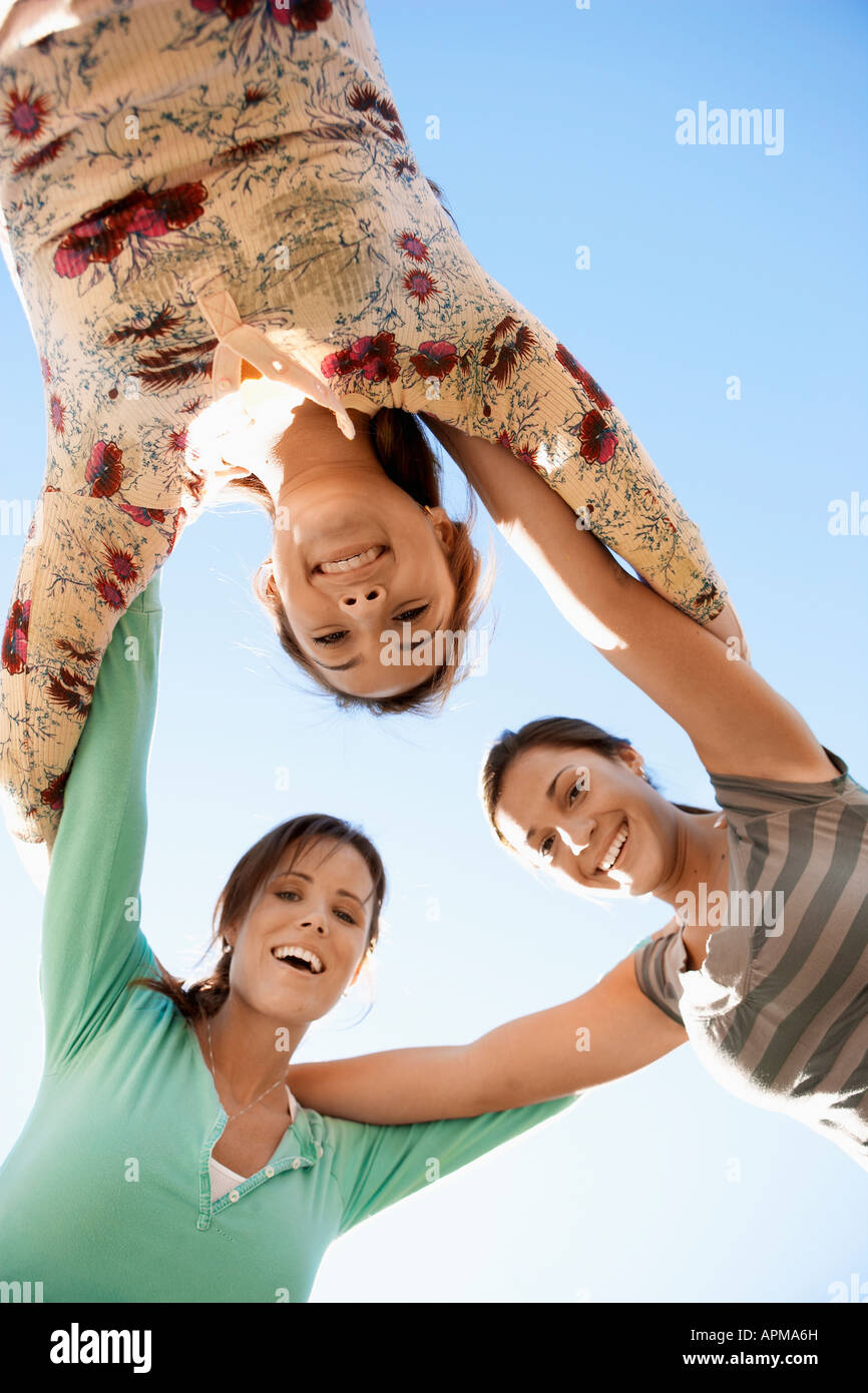 Three young women huddling (directly below Stock Photo - Alamy