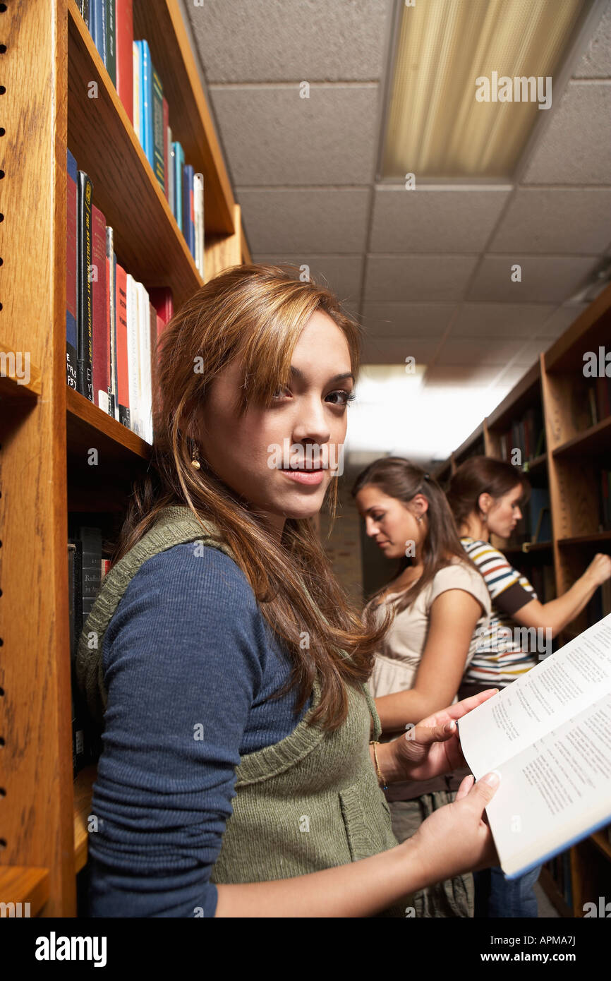 Three female students in library Stock Photo - Alamy