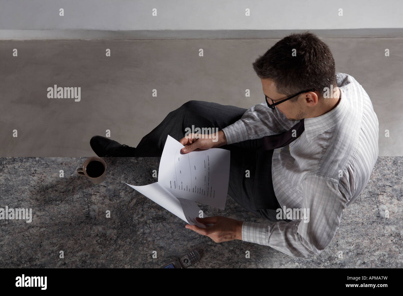 Business man reading paperwork Stock Photo - Alamy