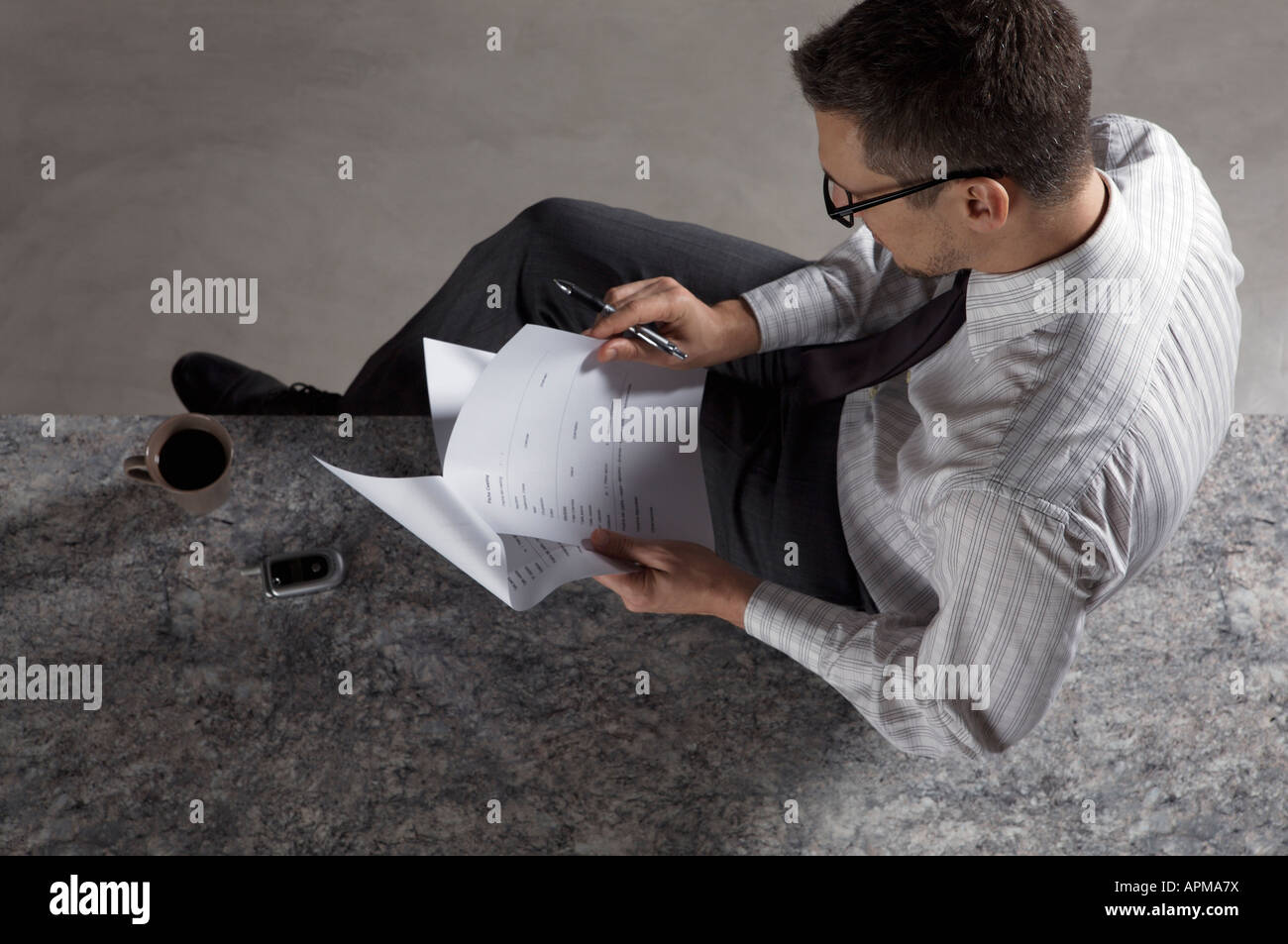 Business man reading paperwork Stock Photo - Alamy