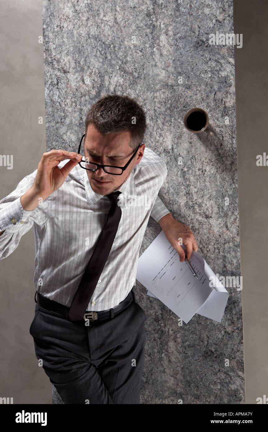 Business man lying down on table Stock Photo - Alamy