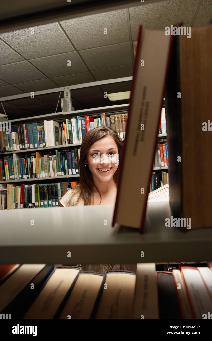 Student behind bookcase in library (portrait Stock Photo - Alamy