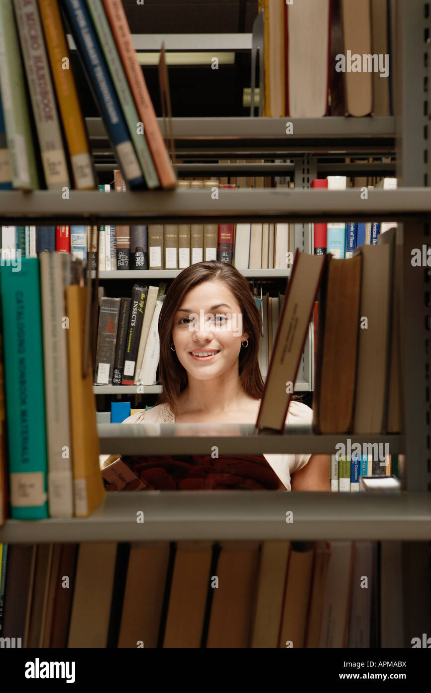 Student behind bookcase in library (portrait Stock Photo - Alamy