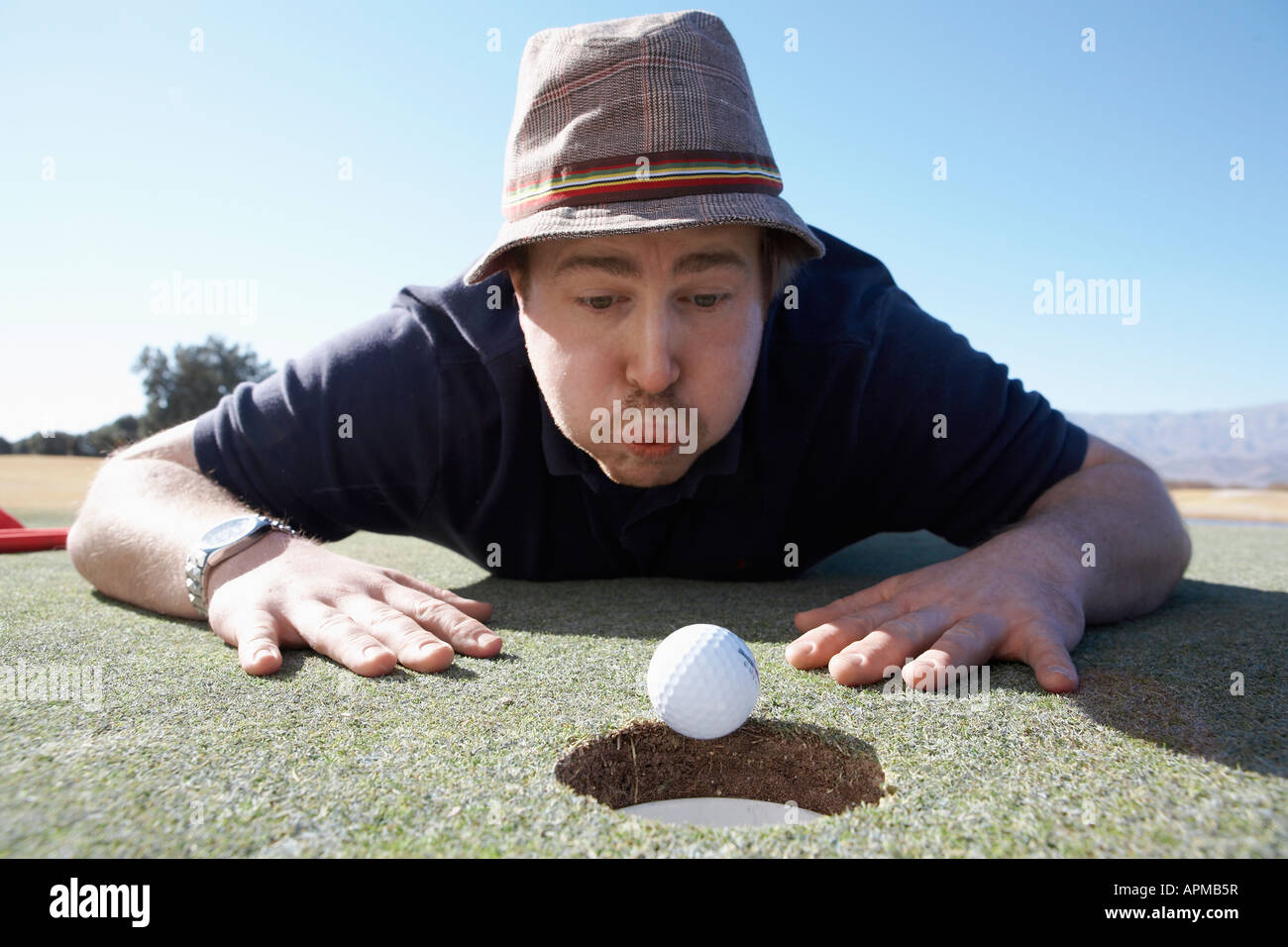 Man lying on golf balls hi-res stock photography and images - Alamy