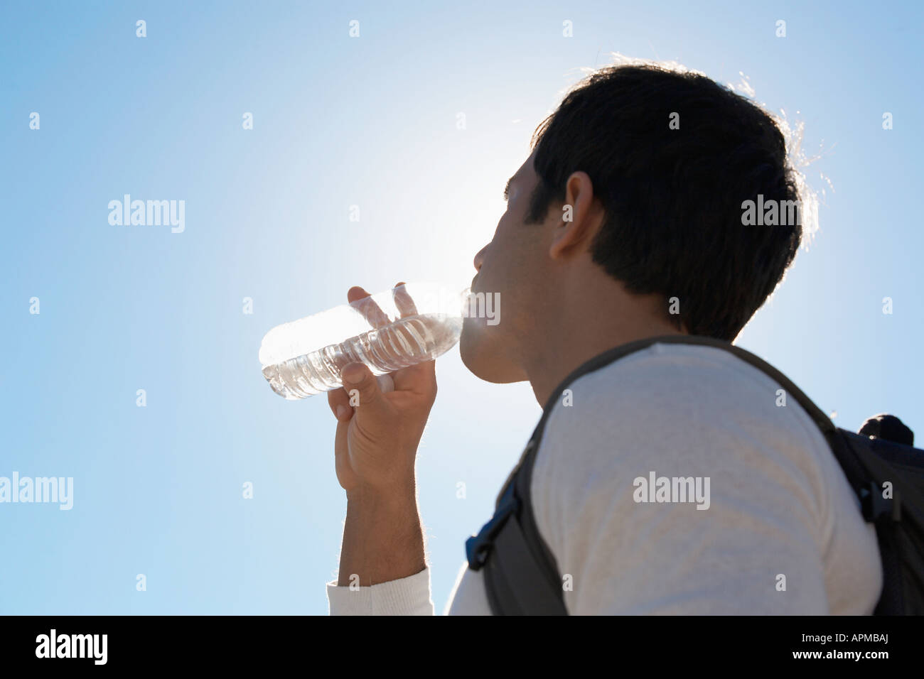 Man drinking water (low angle view Stock Photo - Alamy