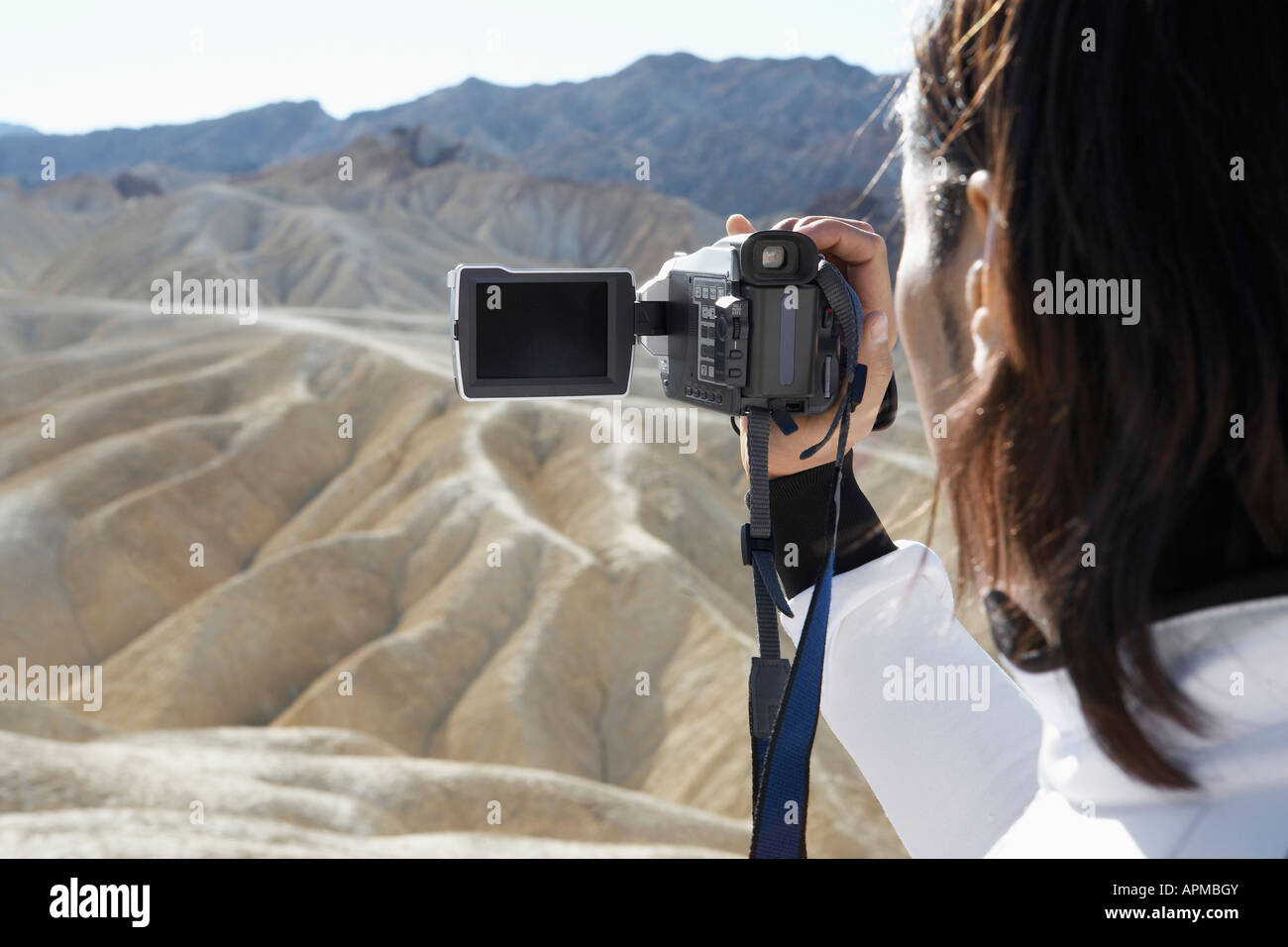 Man using video camera in desert Stock Photo - Alamy