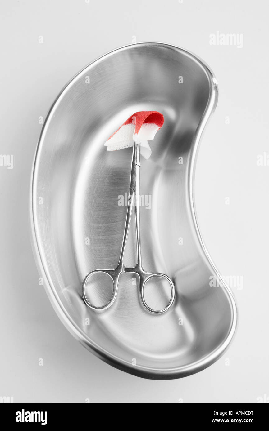 Medical scissors and blood stained swab in kidney dish Stock Photo - Alamy