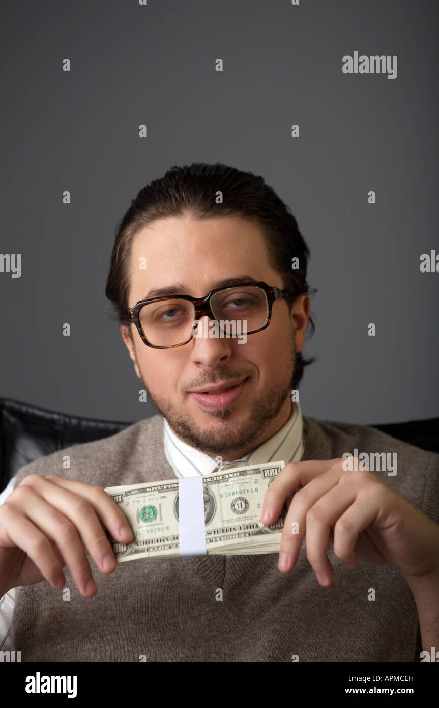 Man holding money bills Stock Photo - Alamy