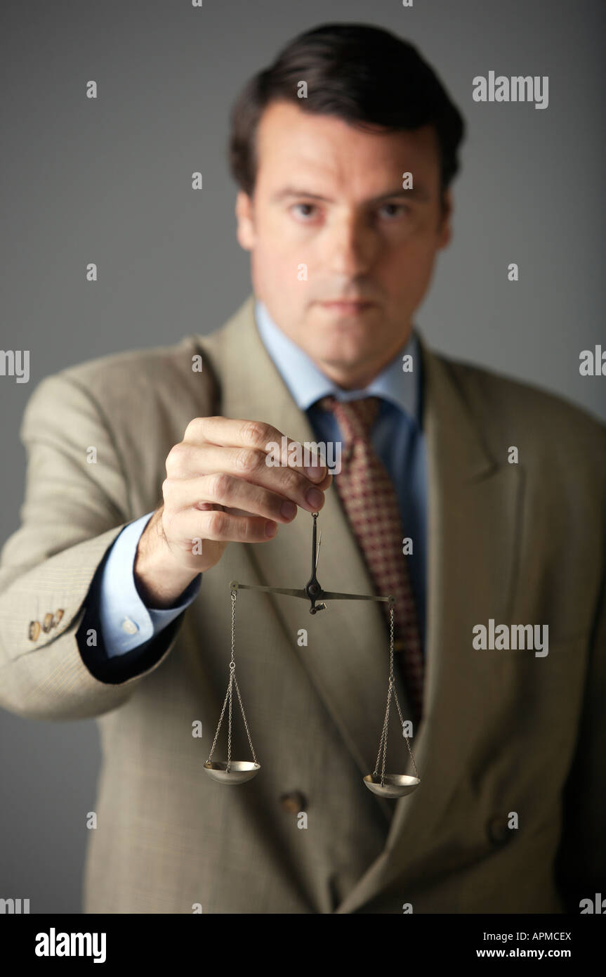 Man holding a balance Stock Photo - Alamy