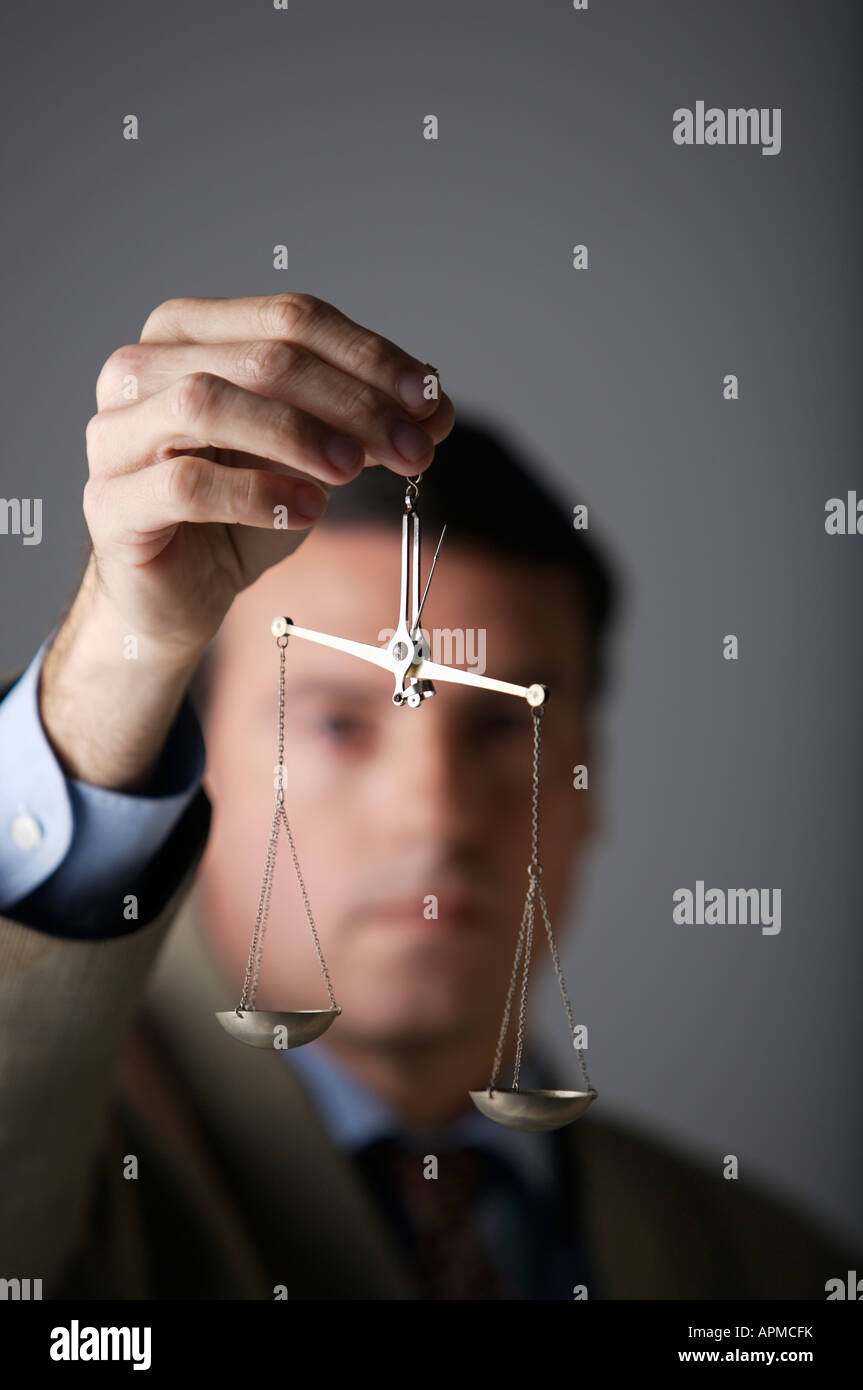 Man holding a balance Stock Photo - Alamy