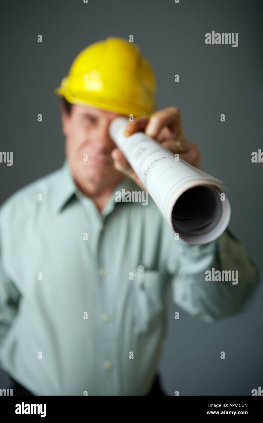 Architect looking inside a plan roll Stock Photo - Alamy