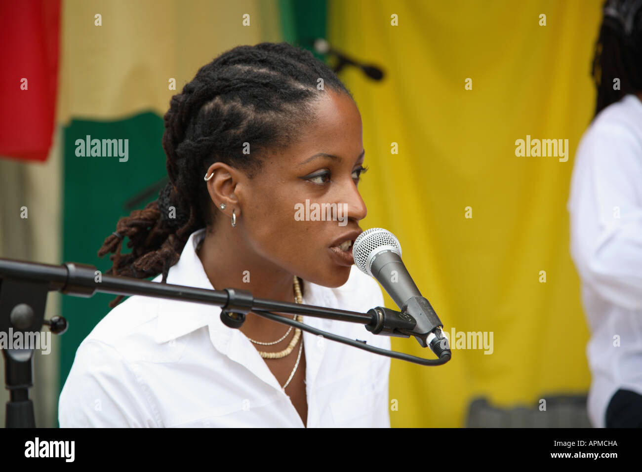 Zimbabwean african singer singing into microphone at Summer Fayre at ...