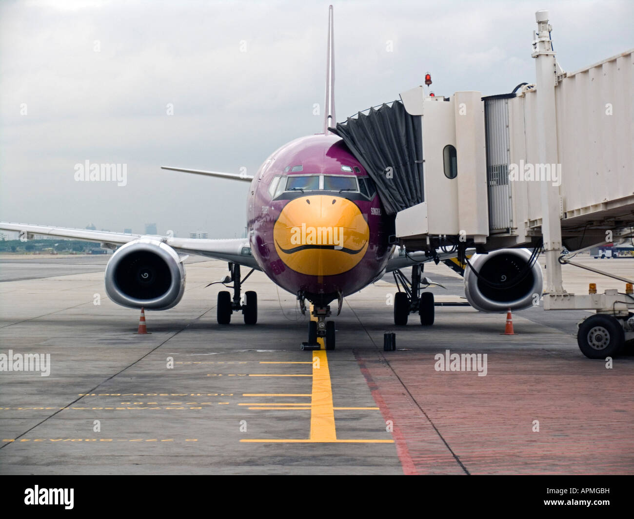 Bird beak nose cone of low cost Nok Air Boeing 737 parked at jetway ...