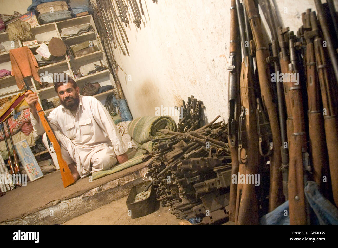A man sitting in his gunshop with in the foreground old WW2 Soviets ...