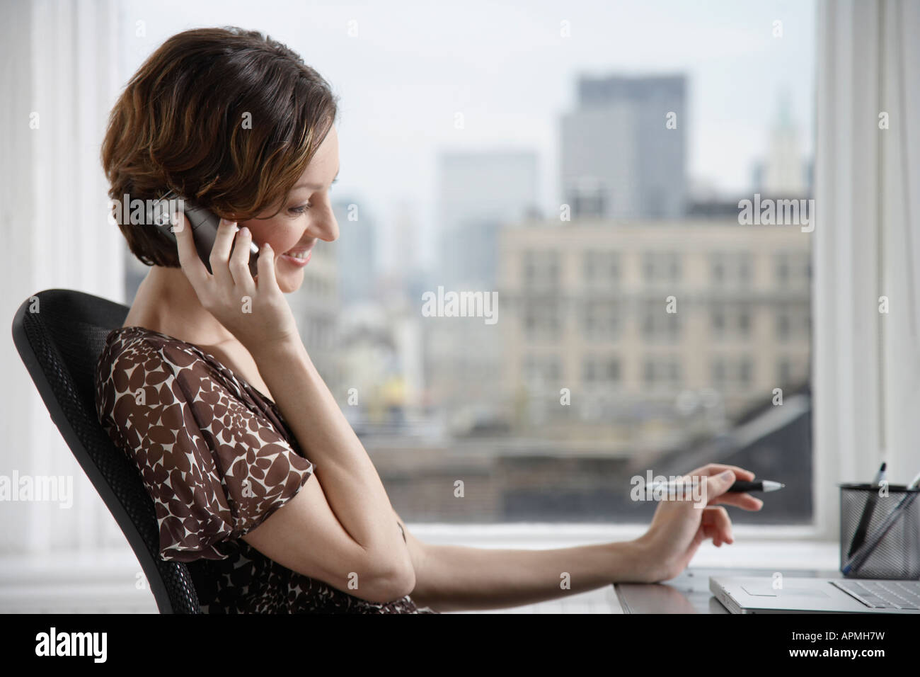 Talking on phone in office desk hi-res stock photography and images - Alamy