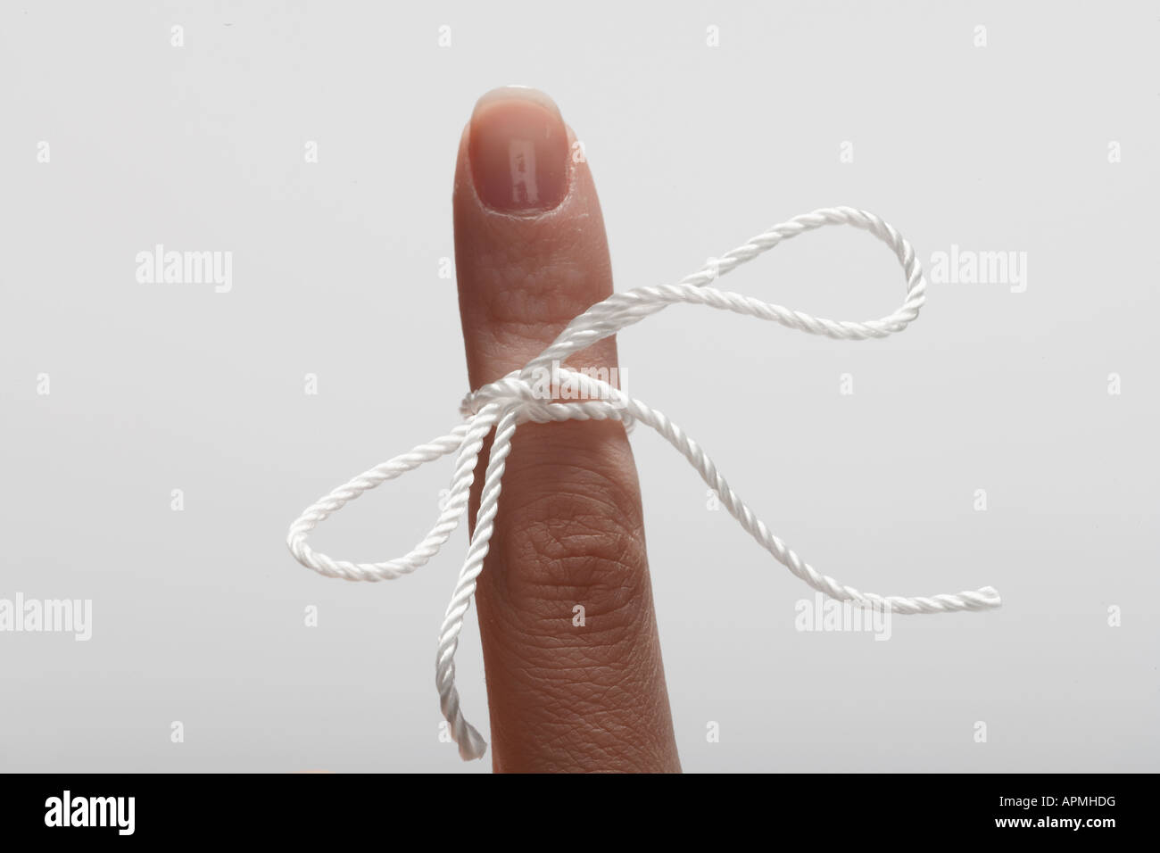 String tied on woman's index finger (close-up Stock Photo - Alamy