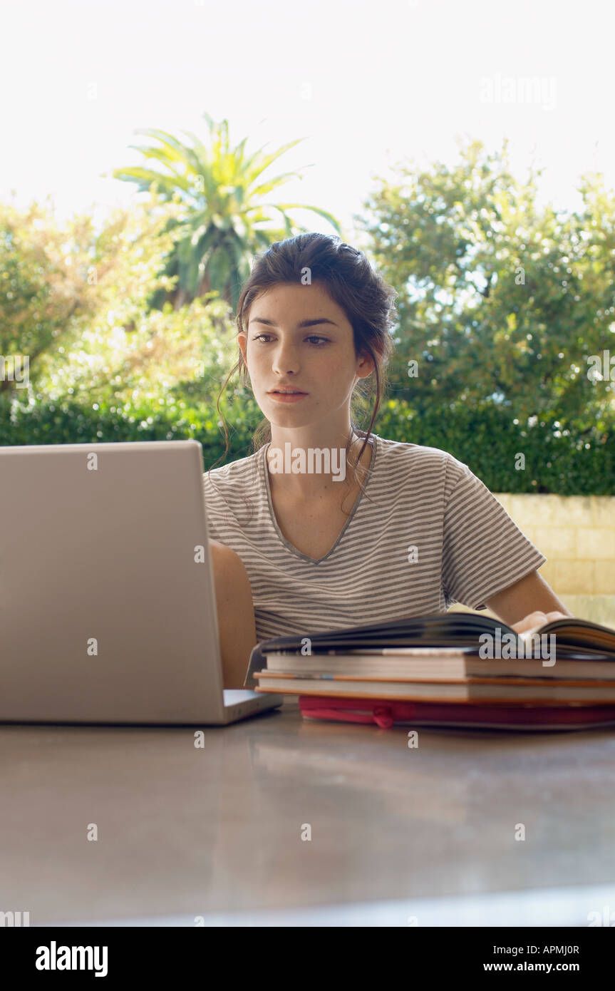 Young woman studying and using laptop Stock Photo - Alamy