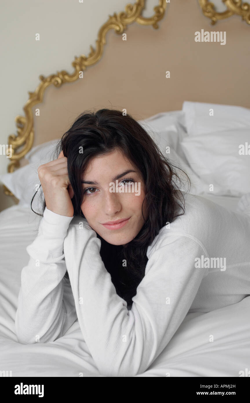 Young woman lying on bed (portrait Stock Photo - Alamy