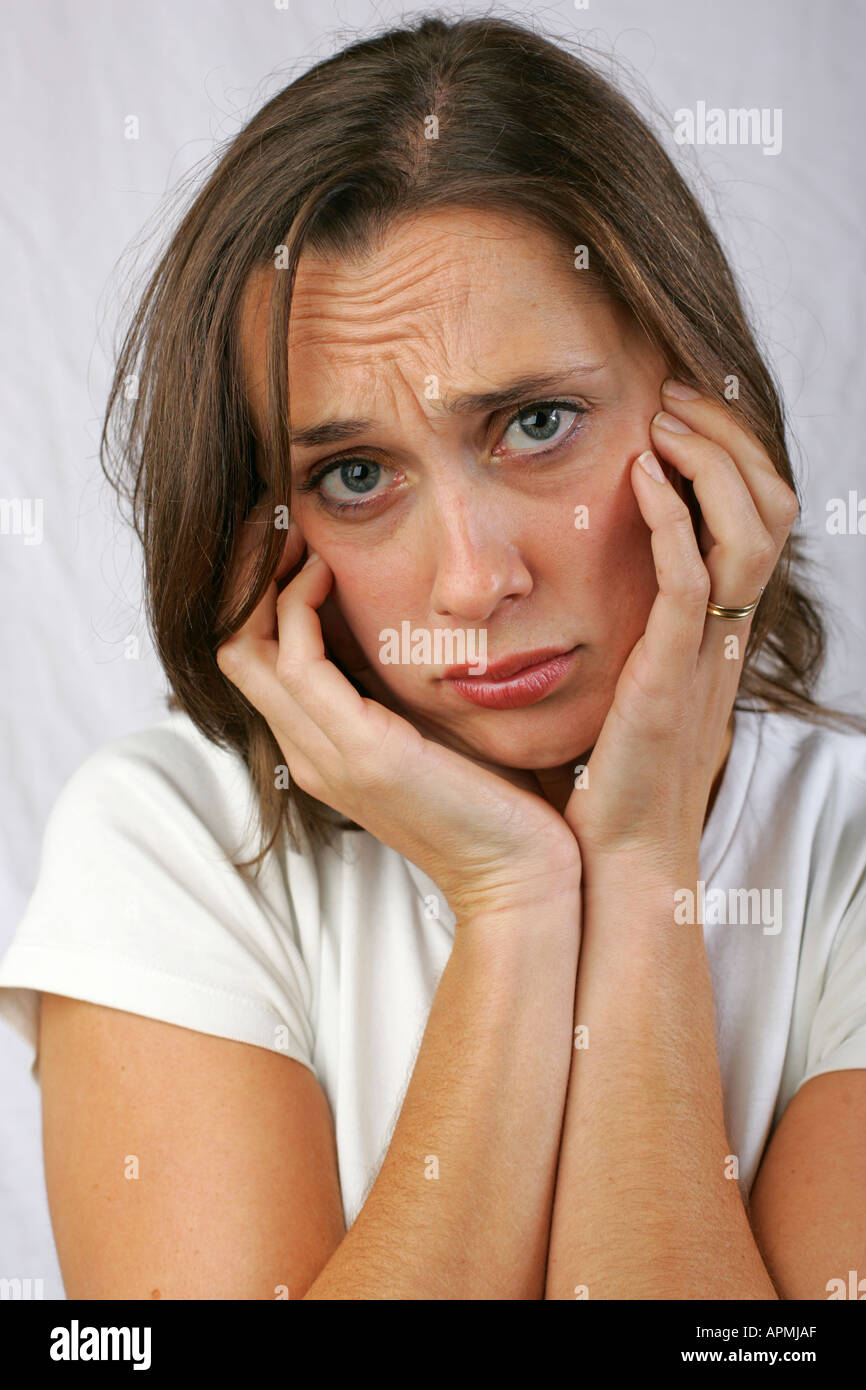 Brunette woman with sad dejected depressed gloomy down glum heartbroken ...