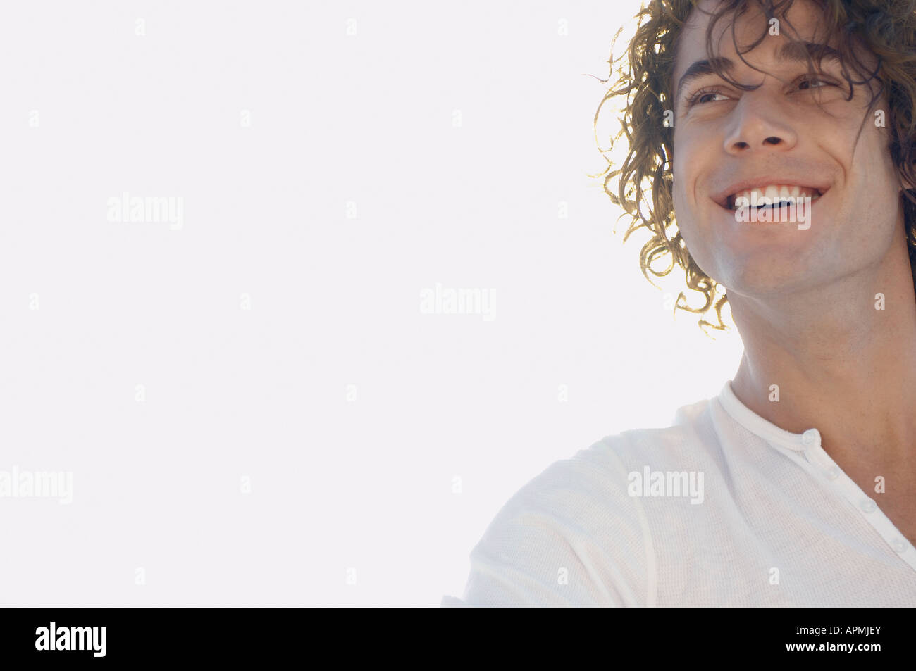 Young man laughing (portrait, low angle view Stock Photo - Alamy