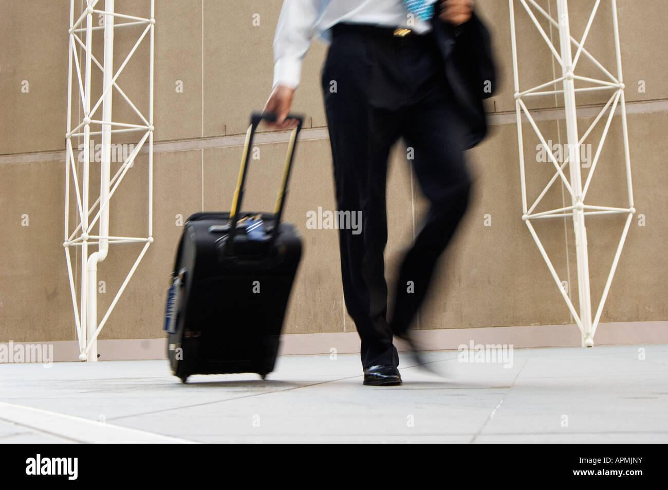 Businessman pulling briefcase (low section Stock Photo - Alamy