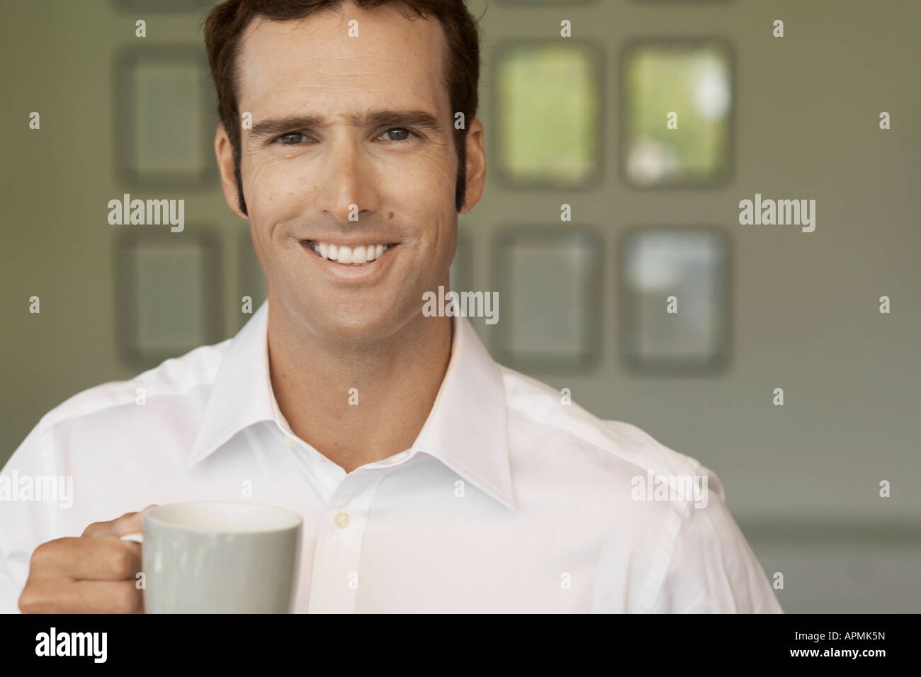 Mid adult man drinking coffee Stock Photo - Alamy
