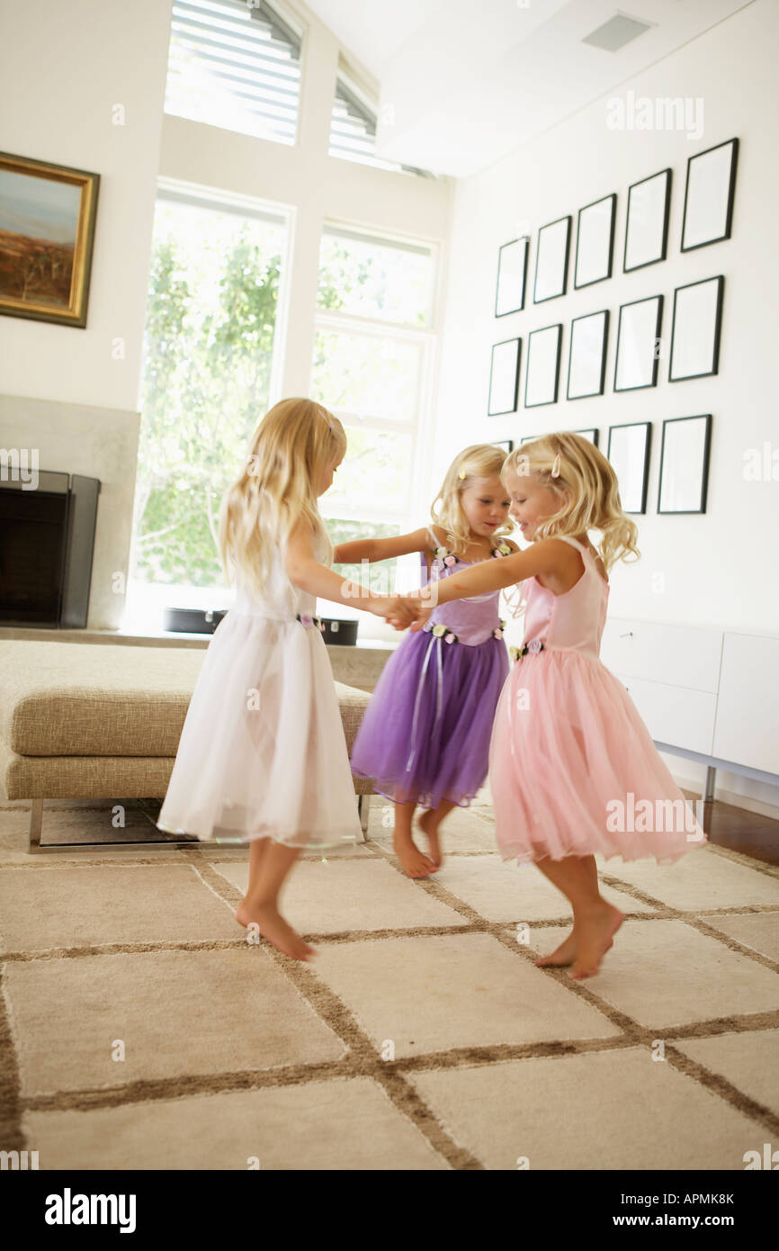 Triplets dancing in living room Stock Photo - Alamy