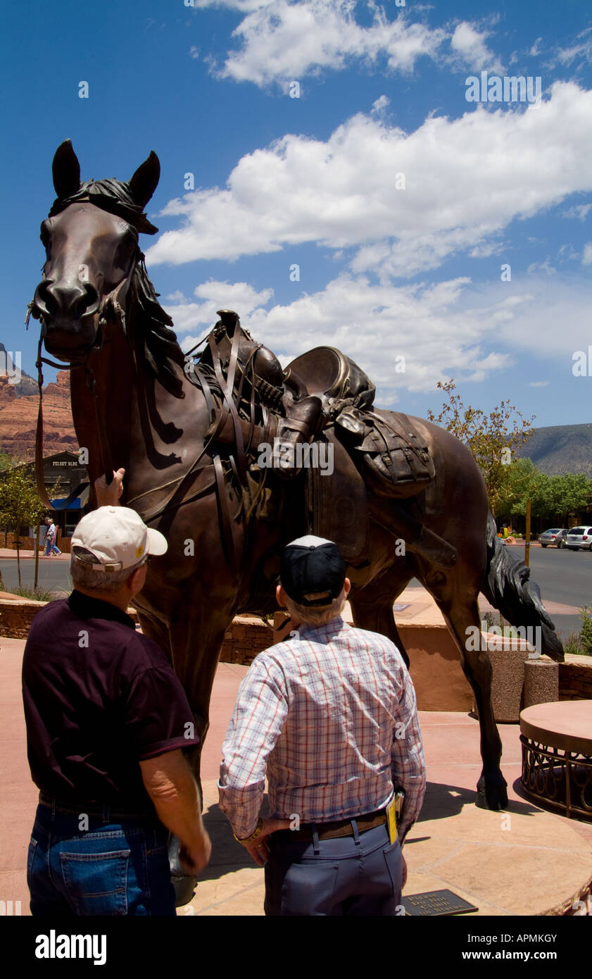 Men looking at large horse statue in Sedona Arizona USA downtown as the ...