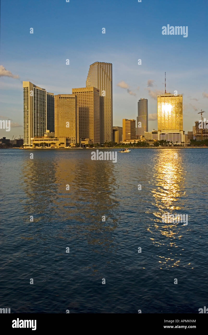 Golden rising sun reflects from highrise office buildings and reflects ...