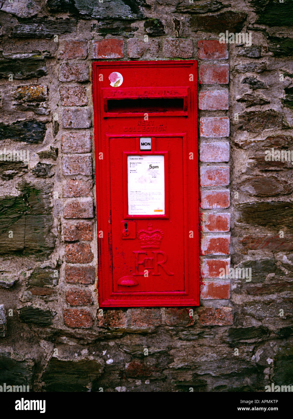 a red post box in a brick wall in the uk Stock Photo - Alamy