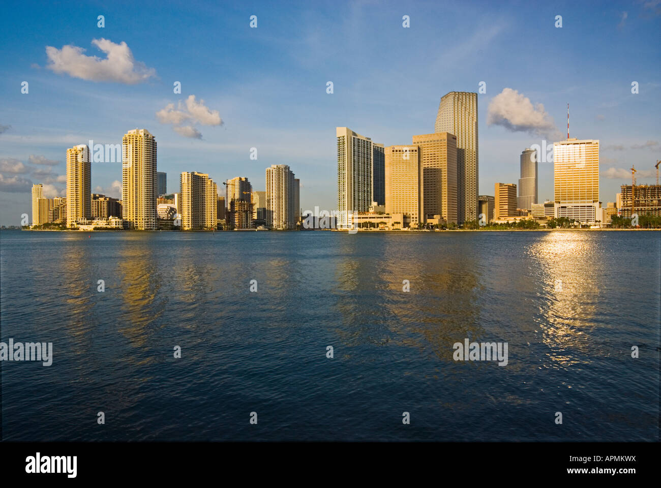 Golden rising sun reflects from high rise office buildings and reflects ...