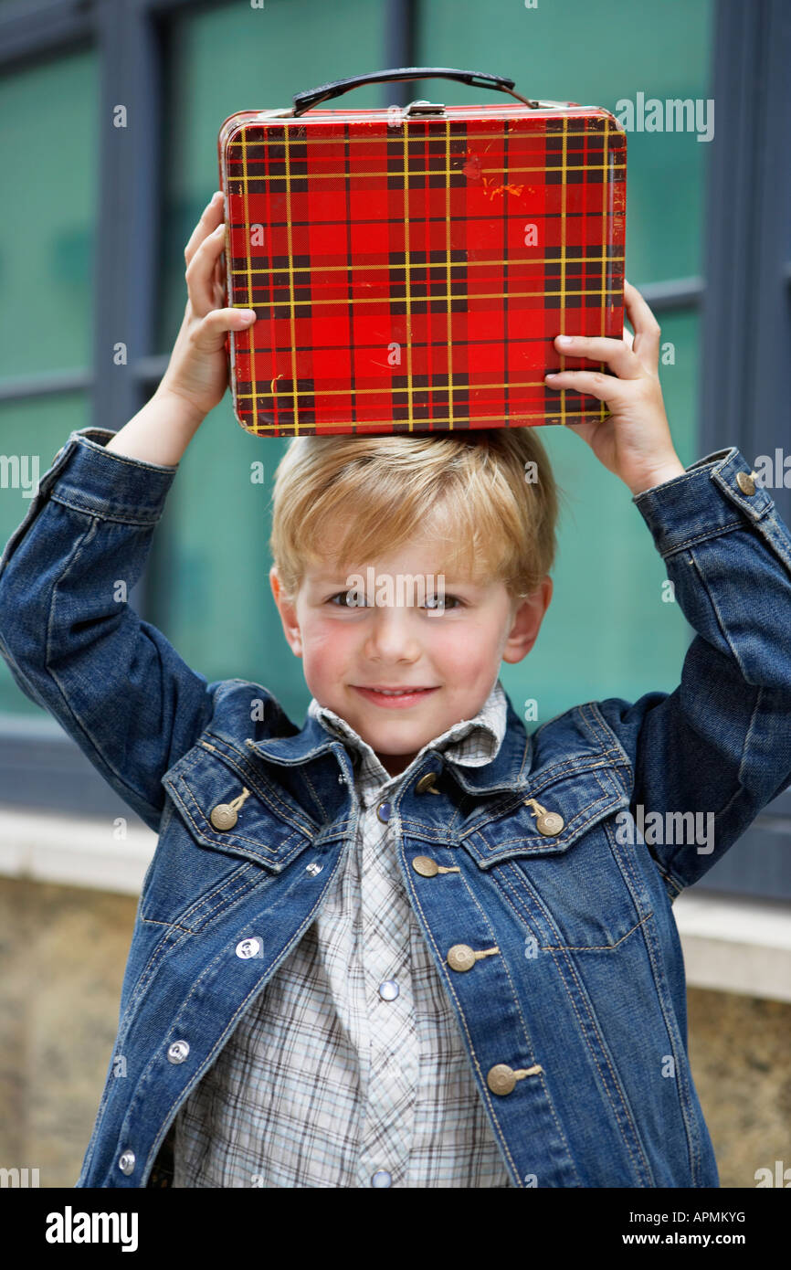 Boy holding briefcase Stock Photo - Alamy