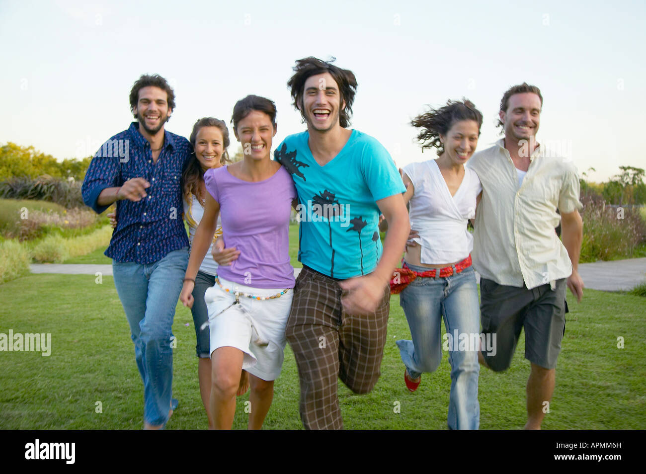 Six young people running in park Stock Photo - Alamy