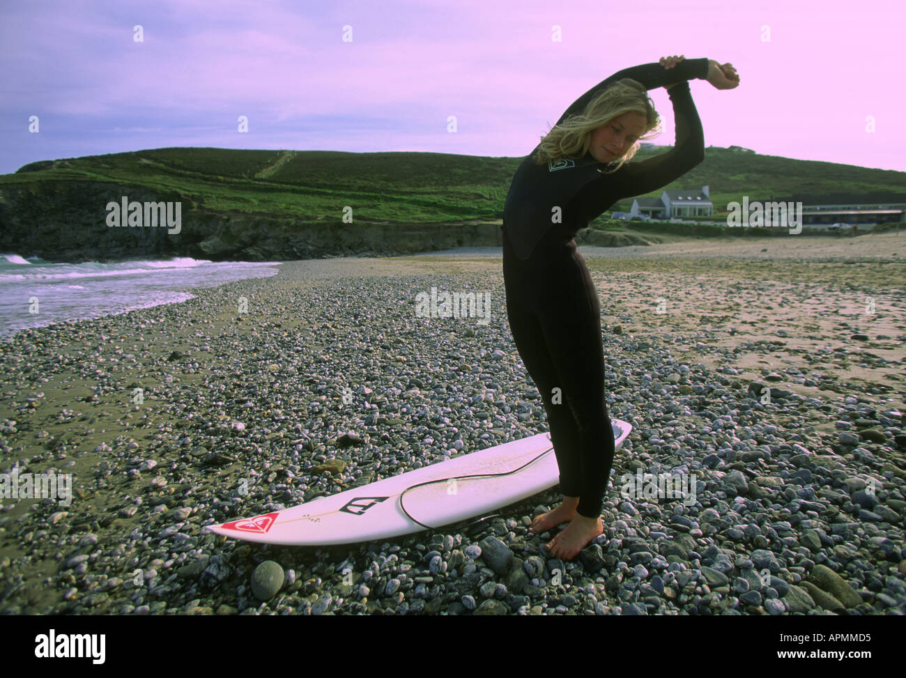 Female surfer stretching on beach, Cornwall Stock Photo - Alamy