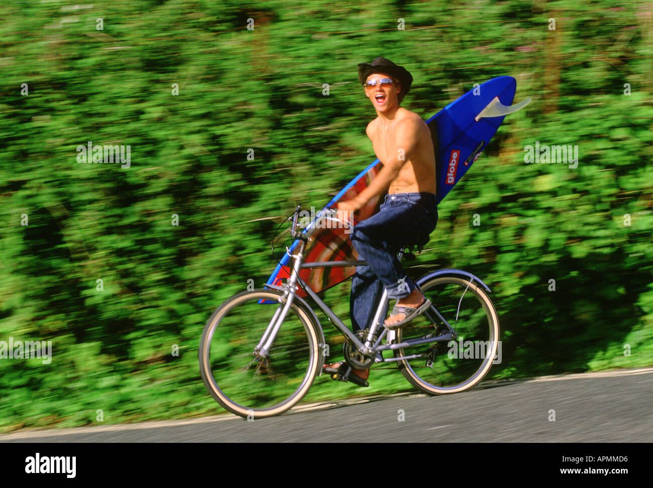 SURFER ON BICYCLE Stock Photo - Alamy