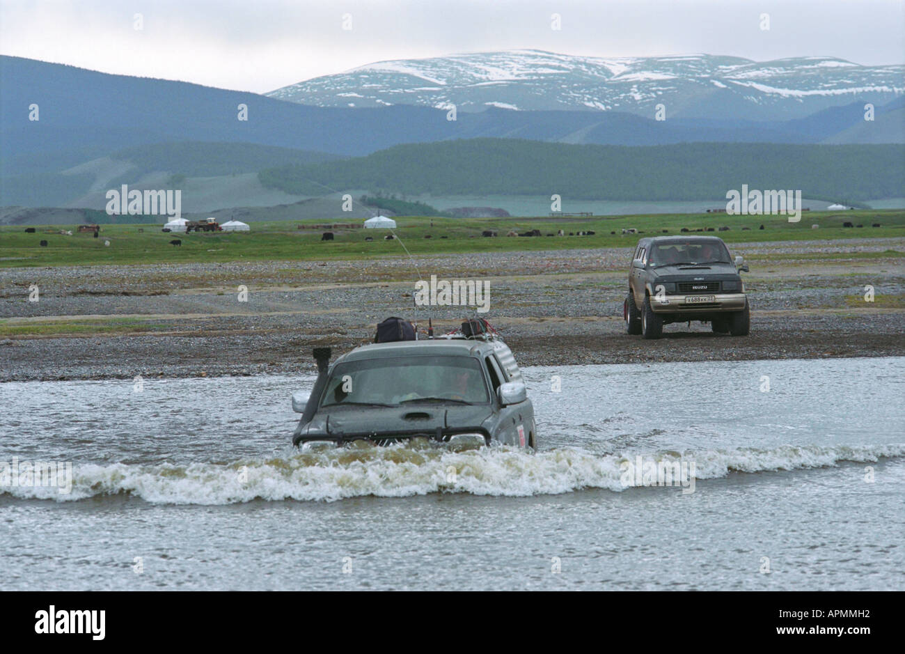 Off-road vehicles cross a river. Darhadyn Wetland. North Mongolia Stock ...