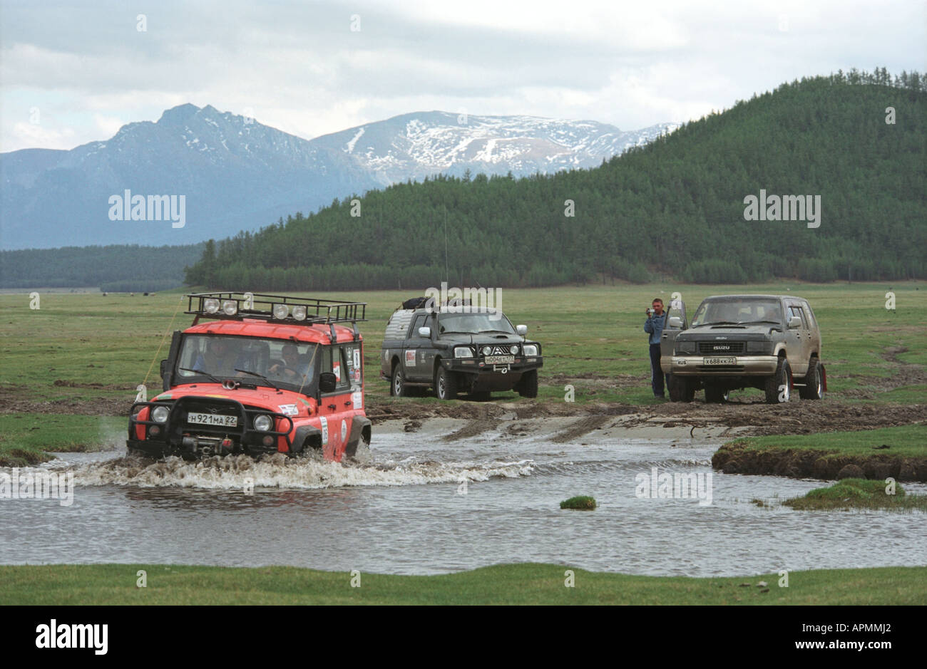 Off-road vehicles cross a river. Darhadyn Wetland. North Mongolia Stock ...