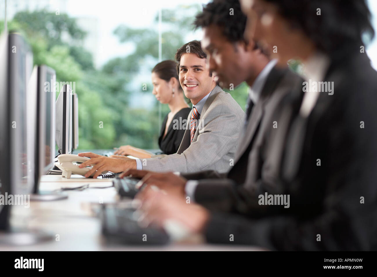 Rows of people working computers hi-res stock photography and images ...